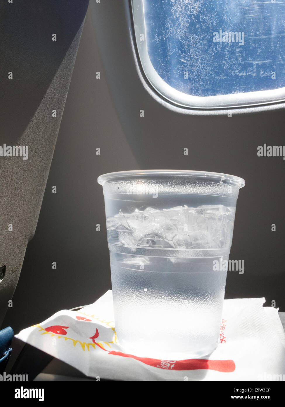 Plastic Cup Filled with Water Aboard Airplane Tray Table, USA Stock ...