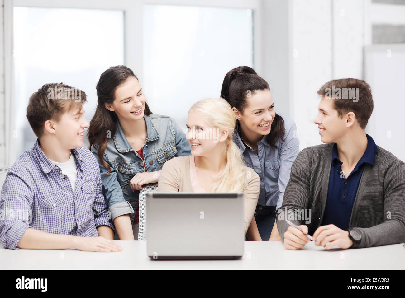 smiling students with laptop at school Stock Photo - Alamy
