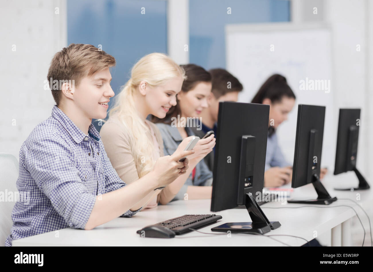 students with computer monitor and smartphones Stock Photo - Alamy