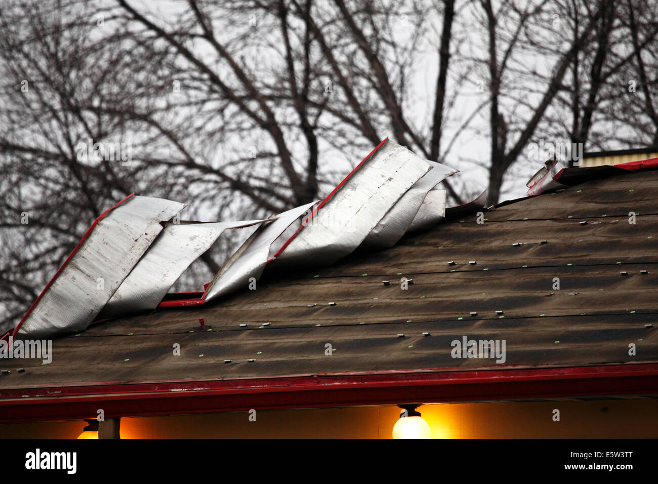 Steel roofing peeled back by high winds Stock Photo - Alamy