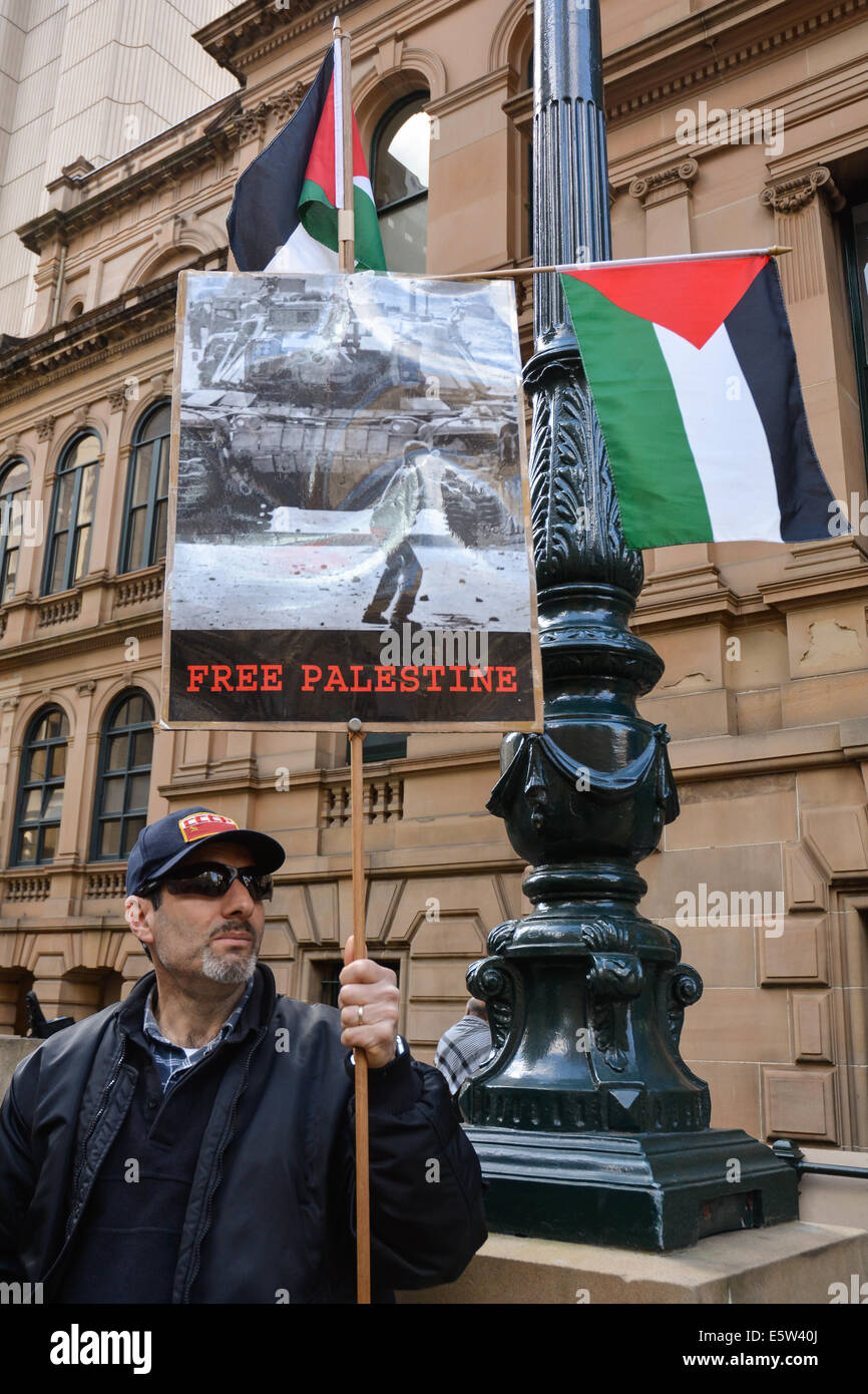 Man holds Palestine flags and a banner that reads "Support Palestine ...