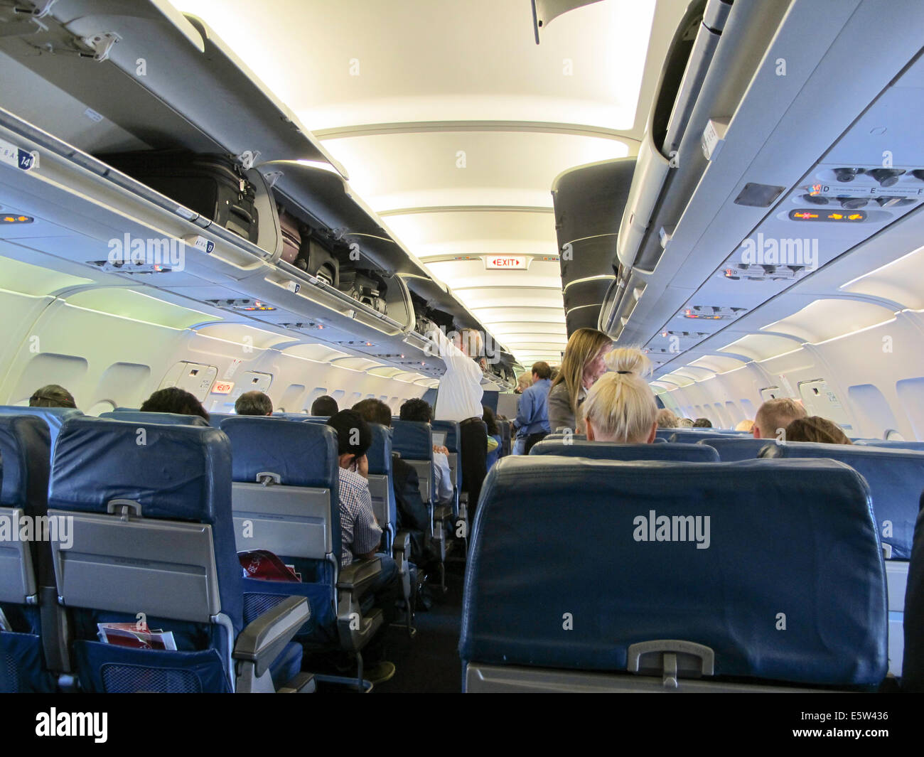 Overhead compartment airplane cabin interior hi-res stock photography ...