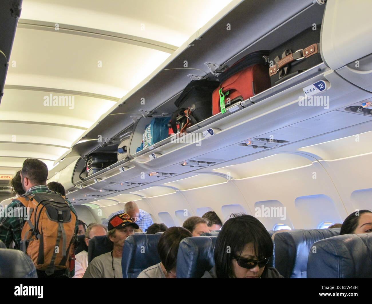 Overhead compartment airplane cabin interior hi-res stock photography ...