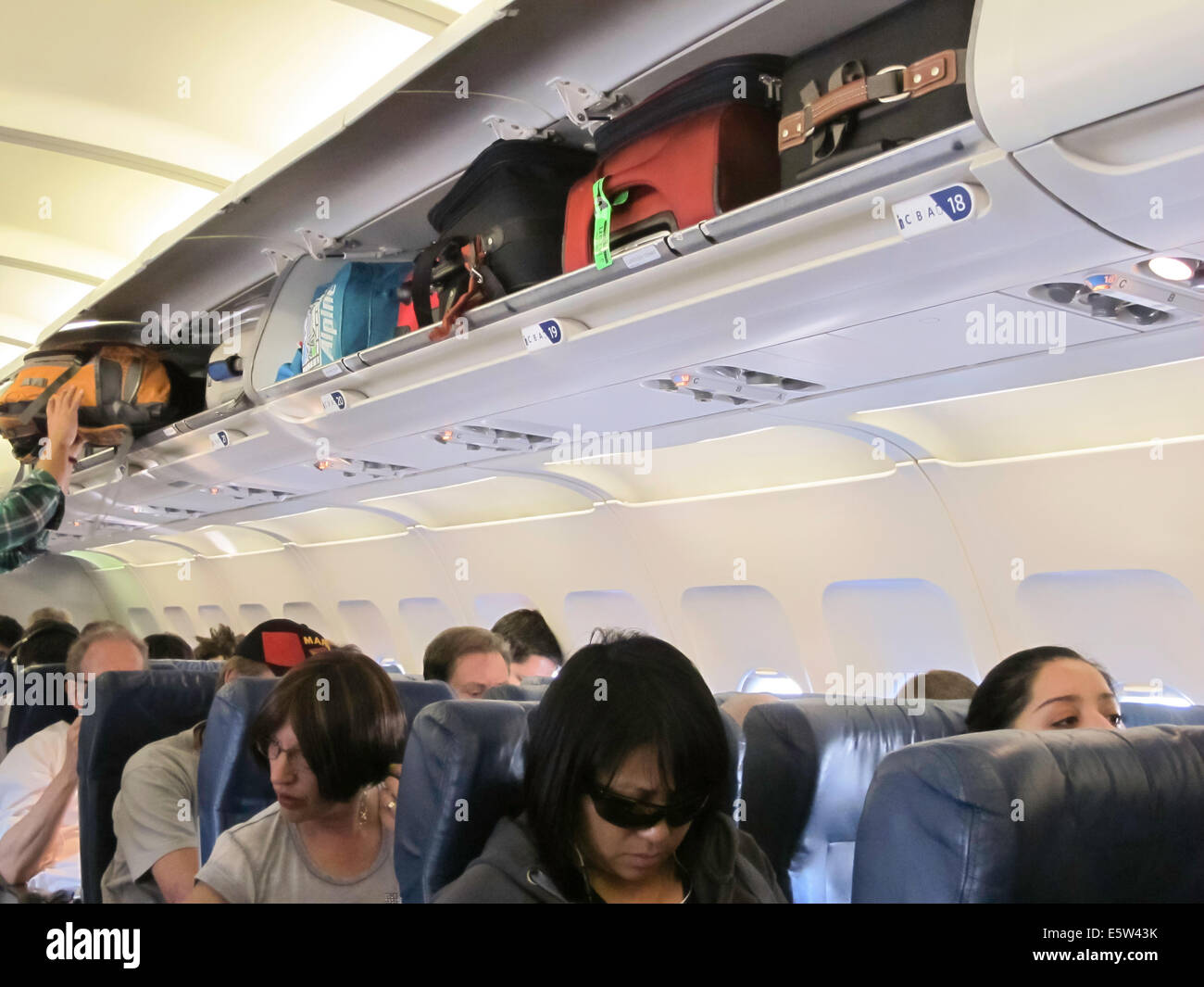 Overhead compartment airplane cabin interior hi-res stock photography ...