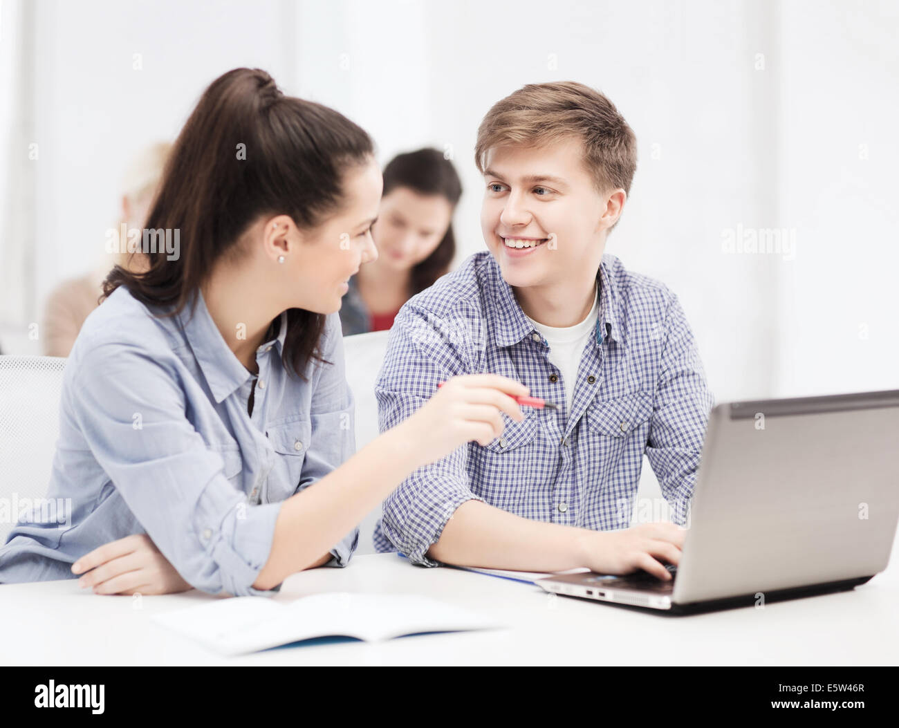 two smiling students with laptop computer Stock Photo - Alamy