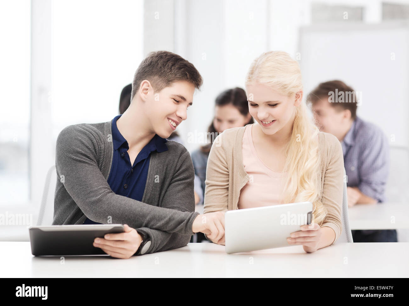 students looking at tablet pc in lecture at school Stock Photo - Alamy