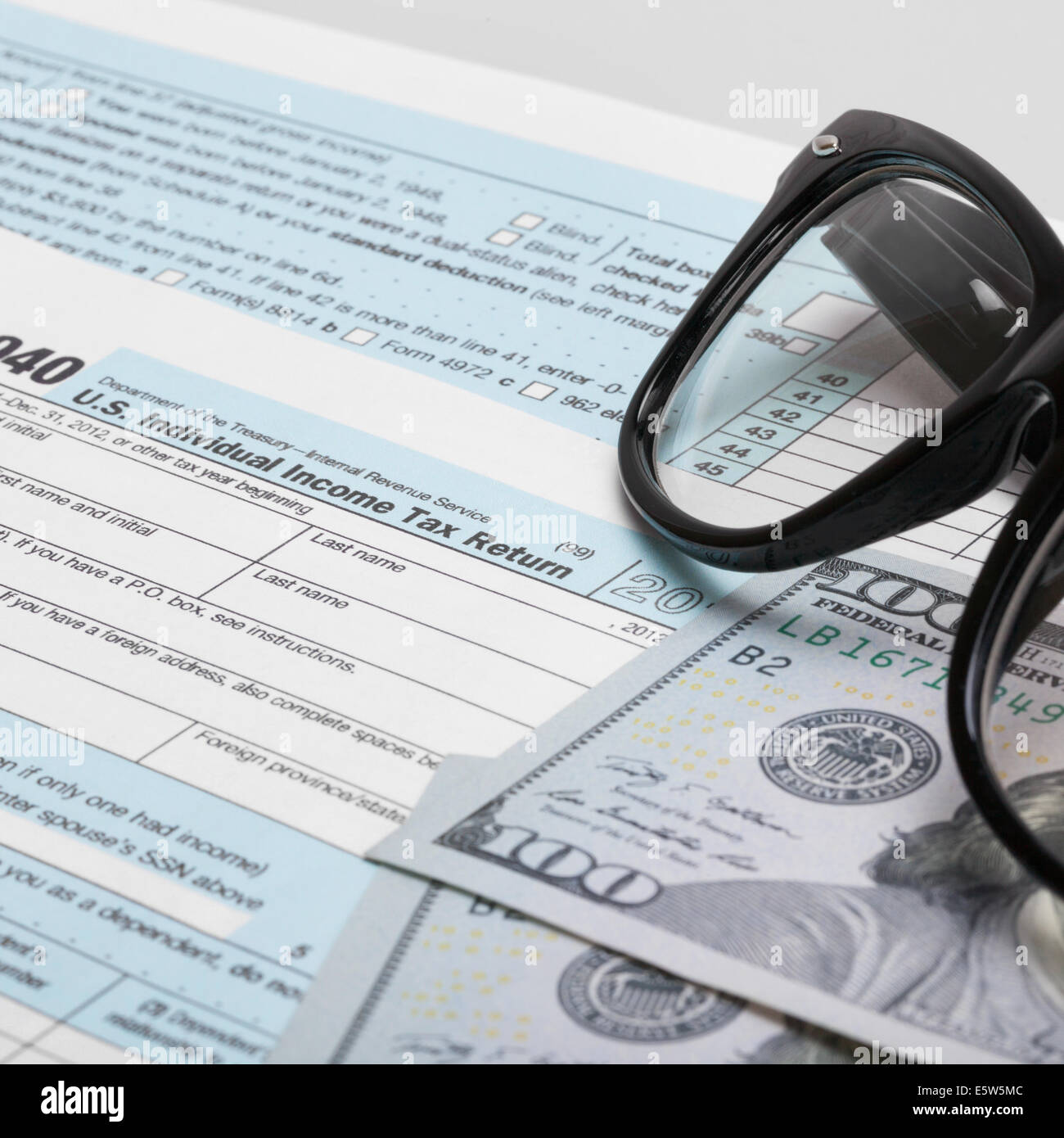 USA 1040 Tax Form with glasses and two 100 US dollar bills - 1 to 1 ...