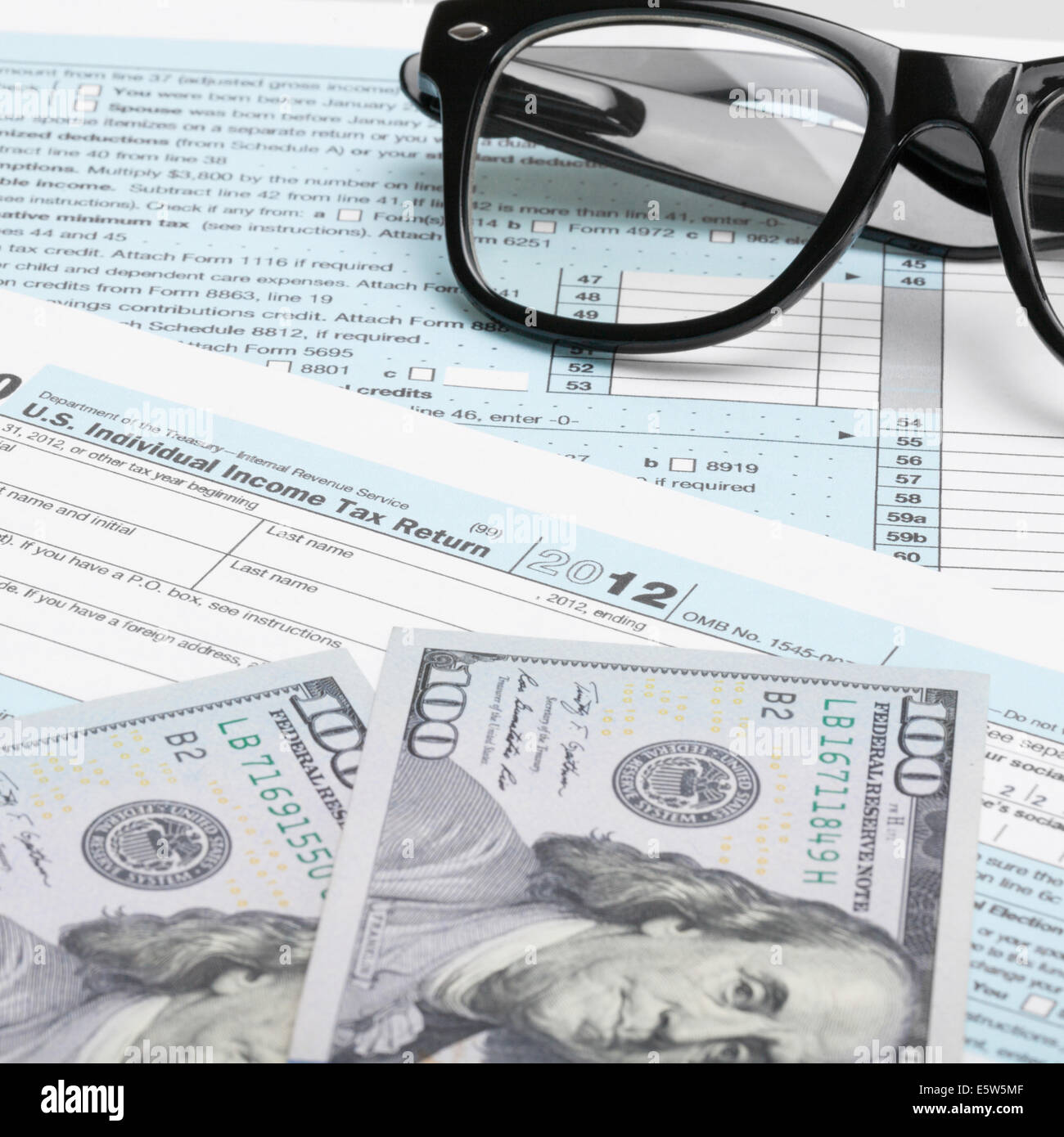 USA Tax Form 1040 with glasses, calculator and 100 US dollar bills - 1 ...