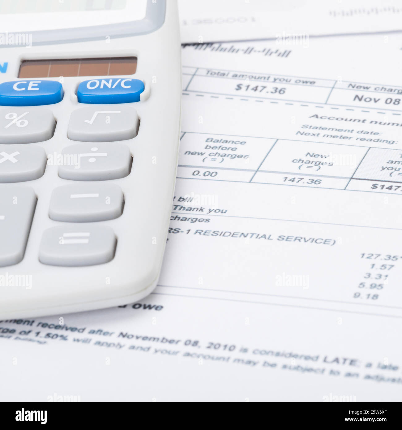 Utility bill and calculator - 1 to 1 ratio Stock Photo - Alamy