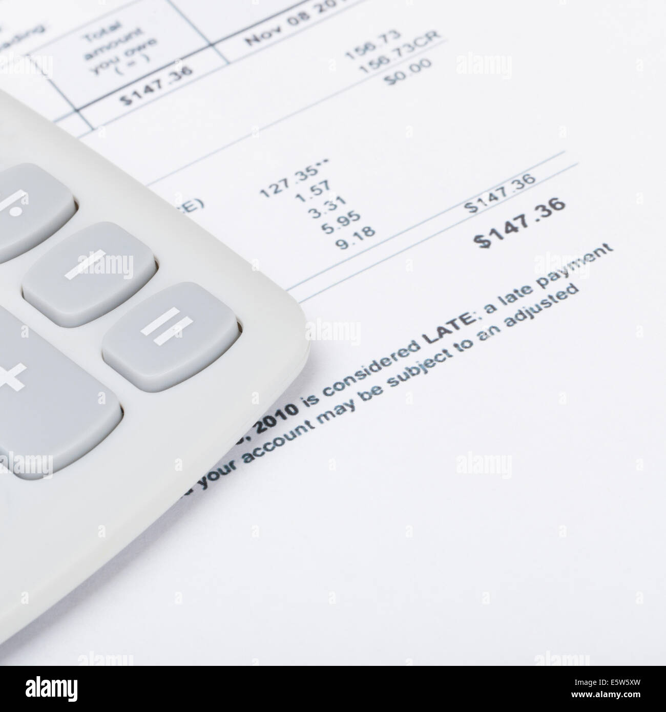 Utility bill with calculator - 1 to 1 ratio Stock Photo - Alamy