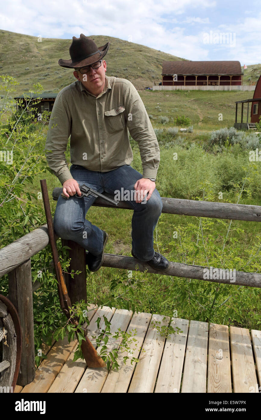 A man with a shotgun at La Reata Ranch near Kyle, Saskatchewan, Canada ...