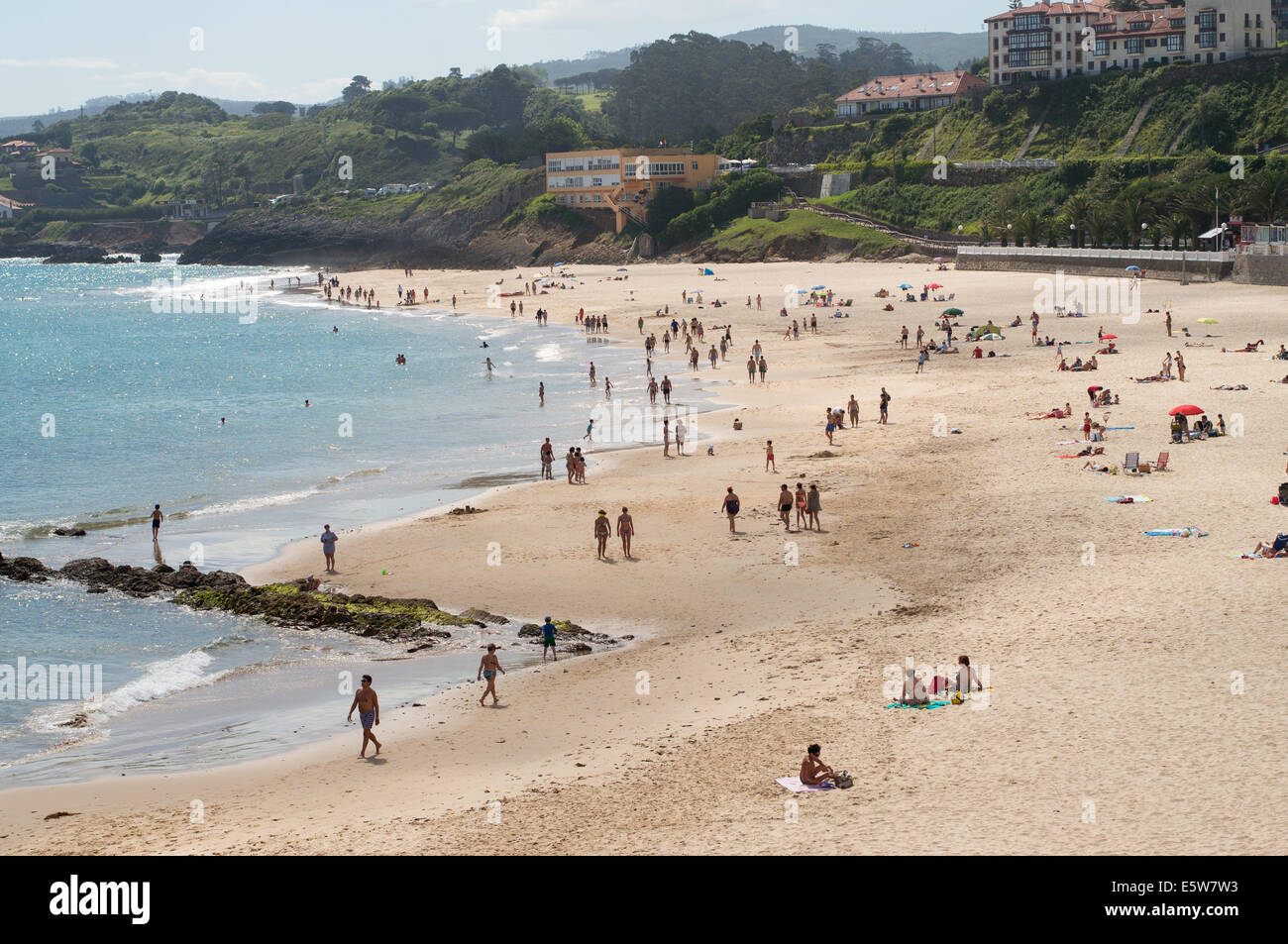 People enjoying sunshine on the beach at Comillas, Cantabria, Northern ...