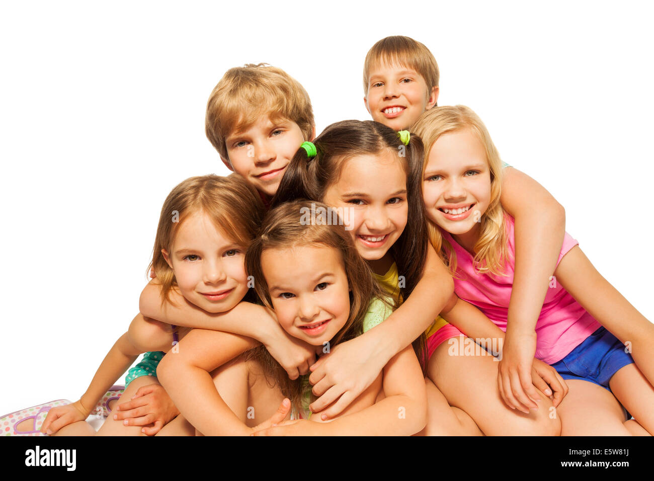 Six children sit hugging together Stock Photo - Alamy