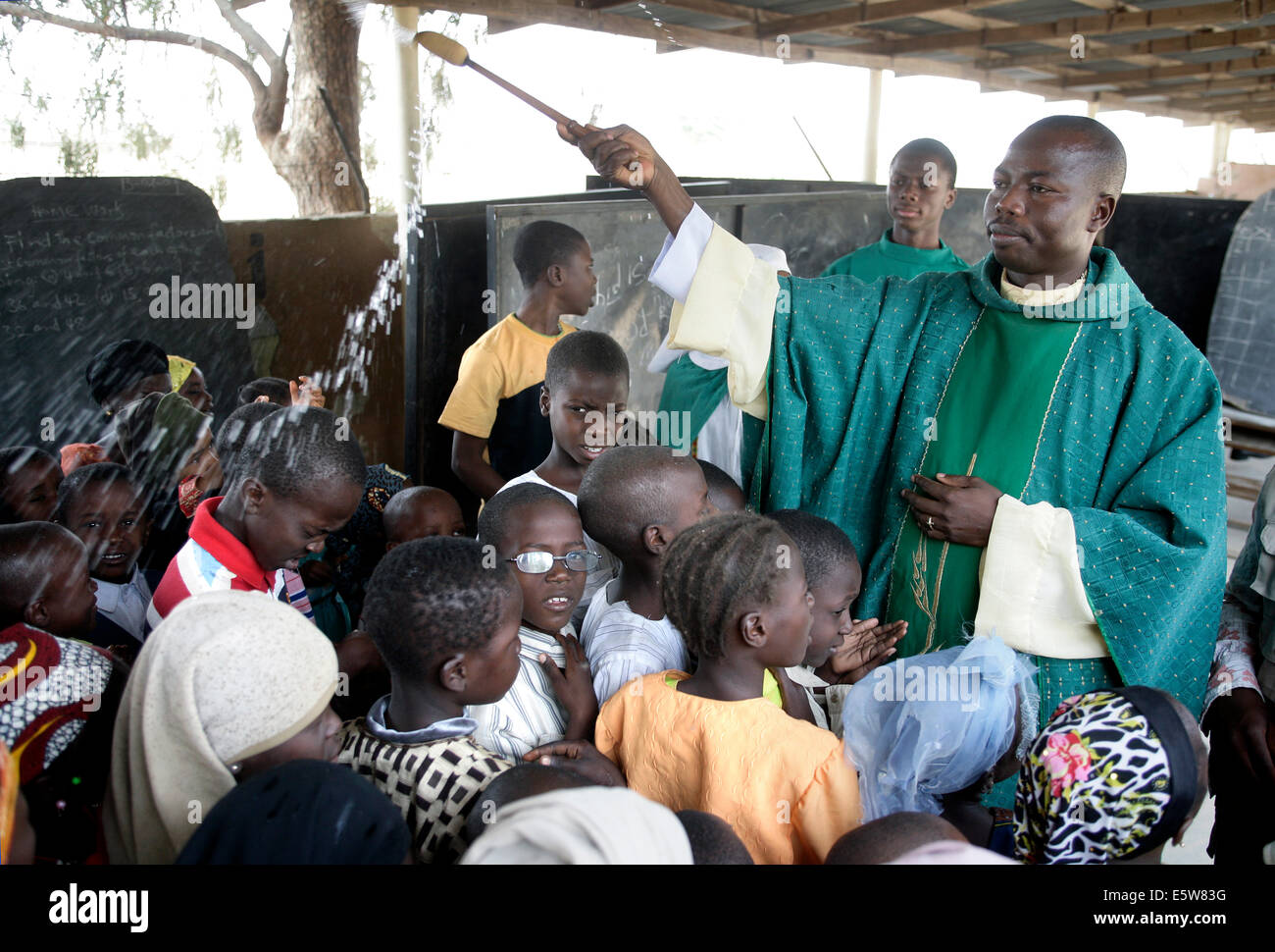 roman catholic priest blesses children after the children's service in ...