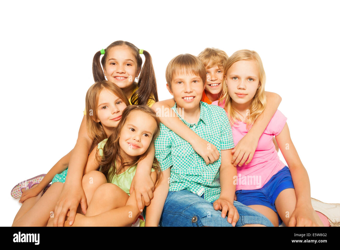 Six smiling children sitting together Stock Photo - Alamy