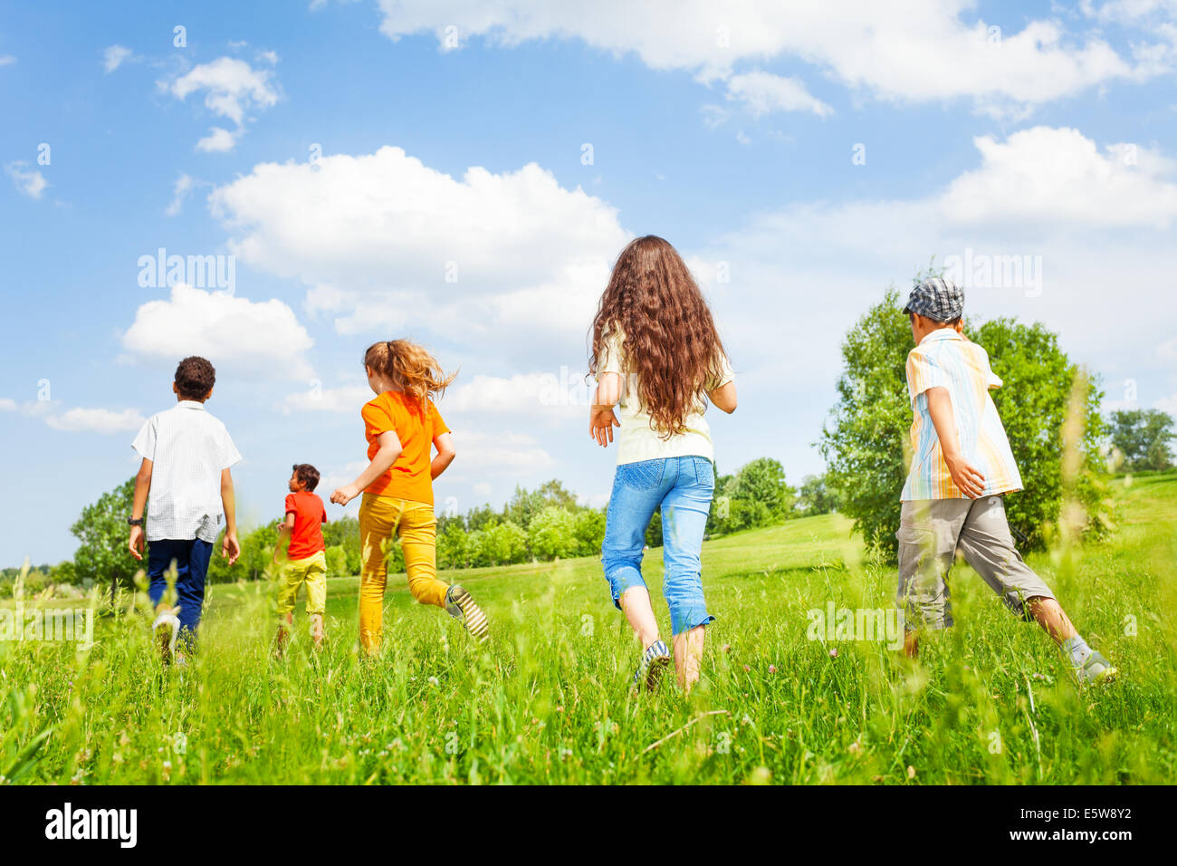 Children back running in other direction Stock Photo - Alamy