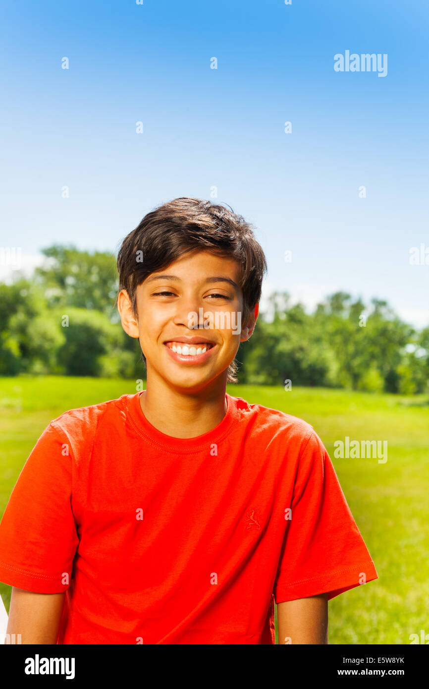 Brunet happy boy in red T-shirt portrait Stock Photo - Alamy