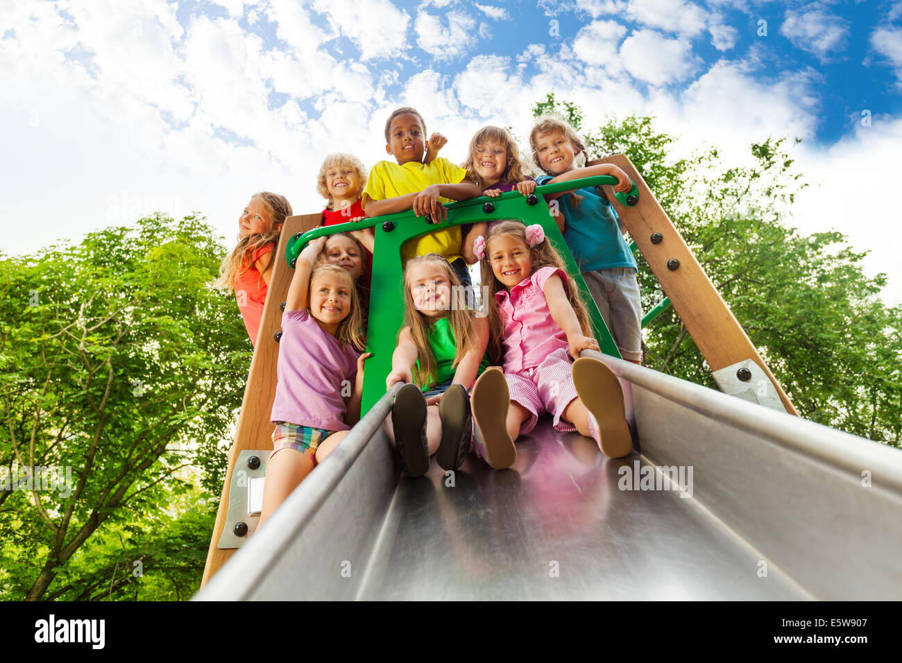 View from below of many kids on playground chute Stock Photo - Alamy