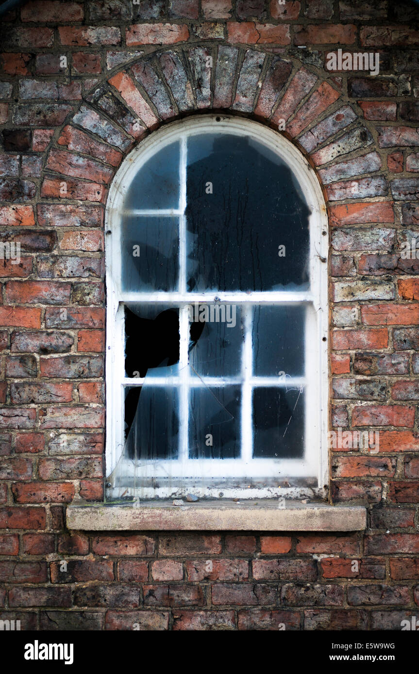 Semi oval window of a derelict building. Red brick, broken glass Stock ...