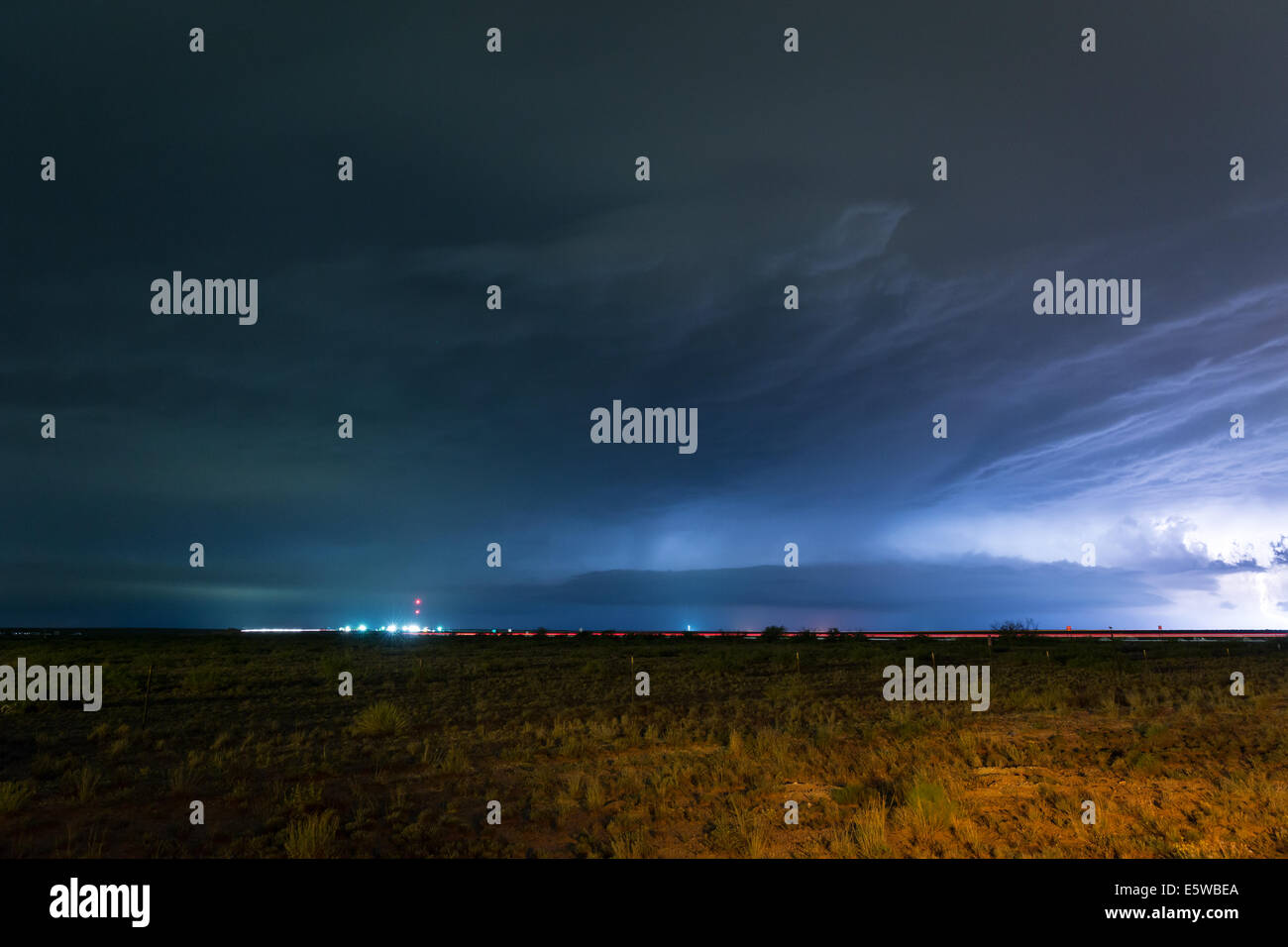 Lightning strikes the ground and flashes across the night sky Stock ...