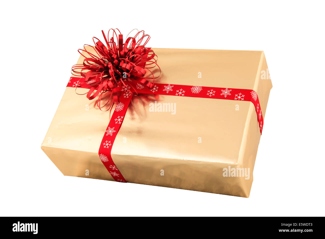 A present wrapped in gold and tied with a red ribbon Stock Photo - Alamy