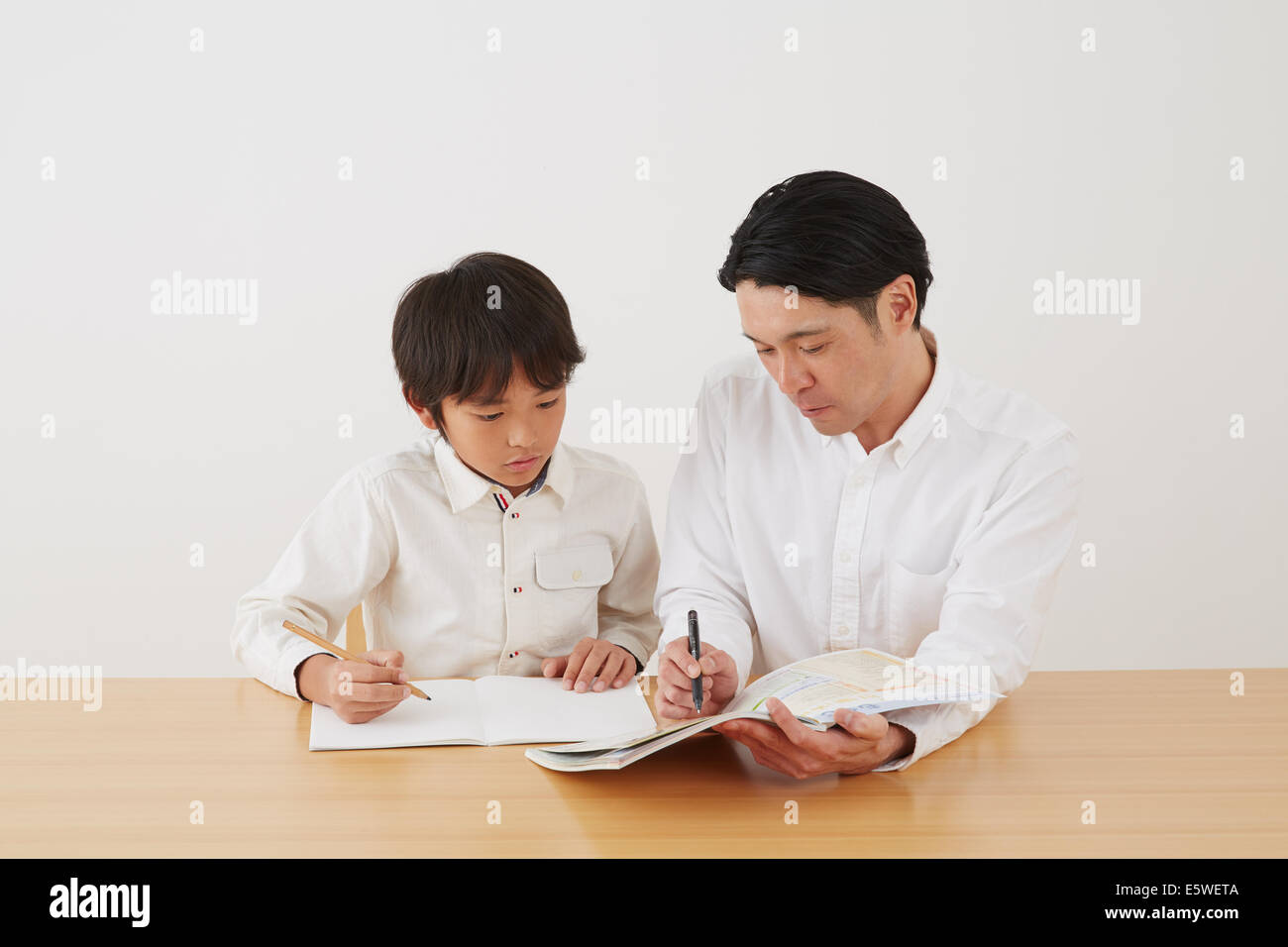 Father helping son with homework Stock Photo - Alamy