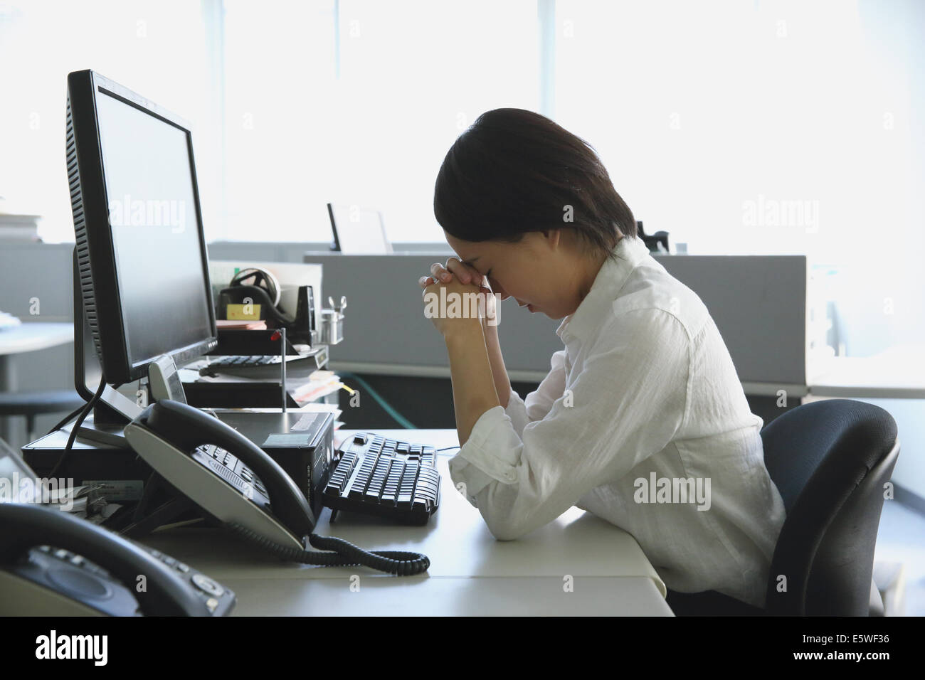 Japanese young businesswoman depressed at her office desk Stock Photo ...
