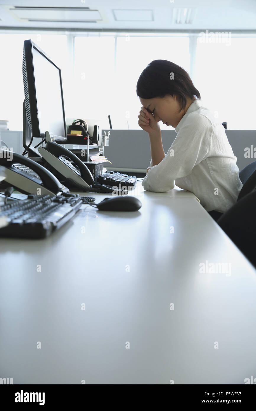 Japanese young businesswoman depressed at her office desk Stock Photo ...