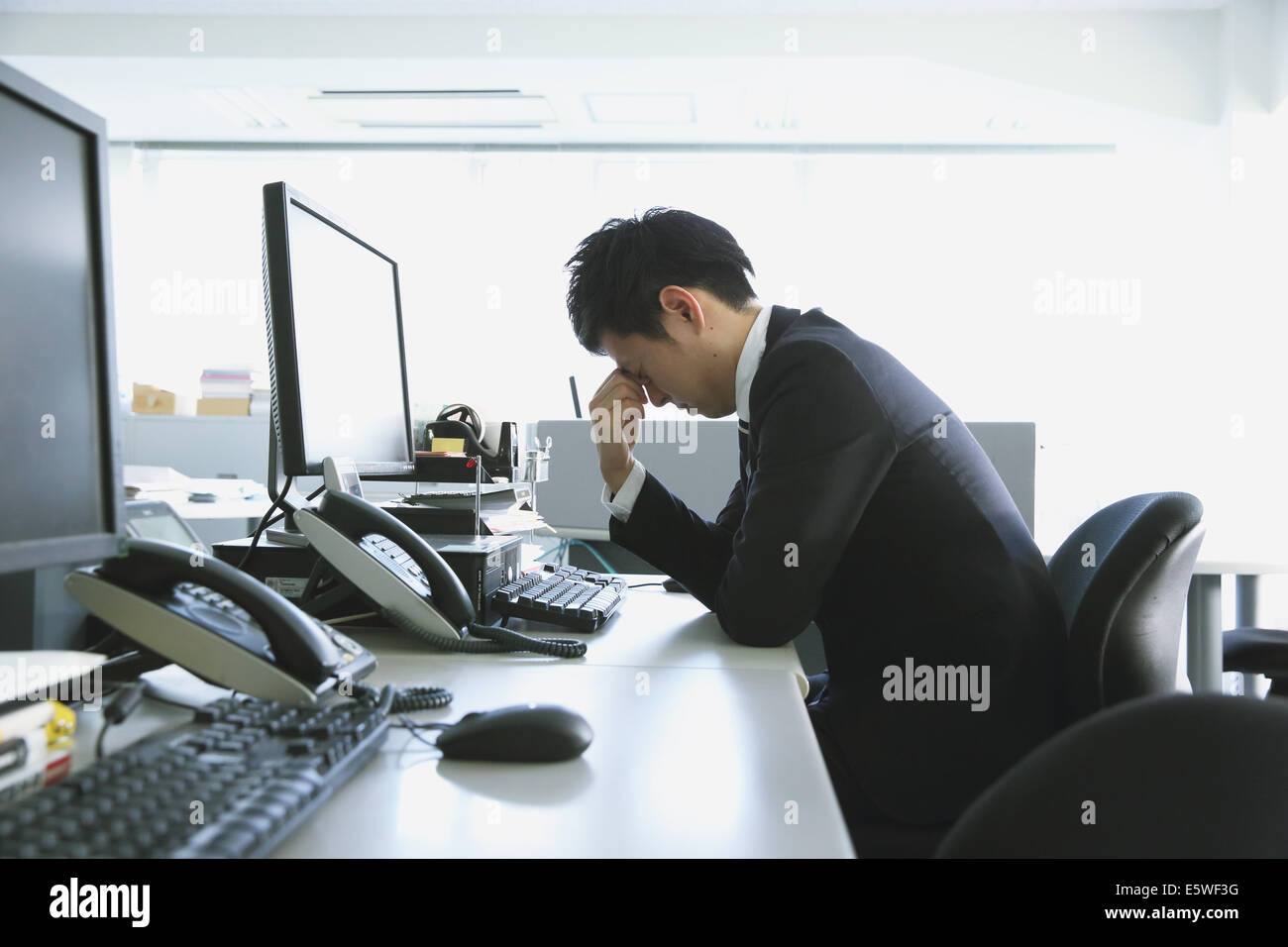 Japanese young businessman depressed at his office desk Stock Photo - Alamy