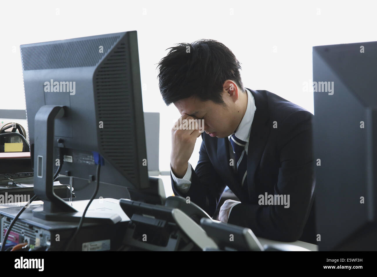 Japanese young businessman depressed at his office desk Stock Photo - Alamy