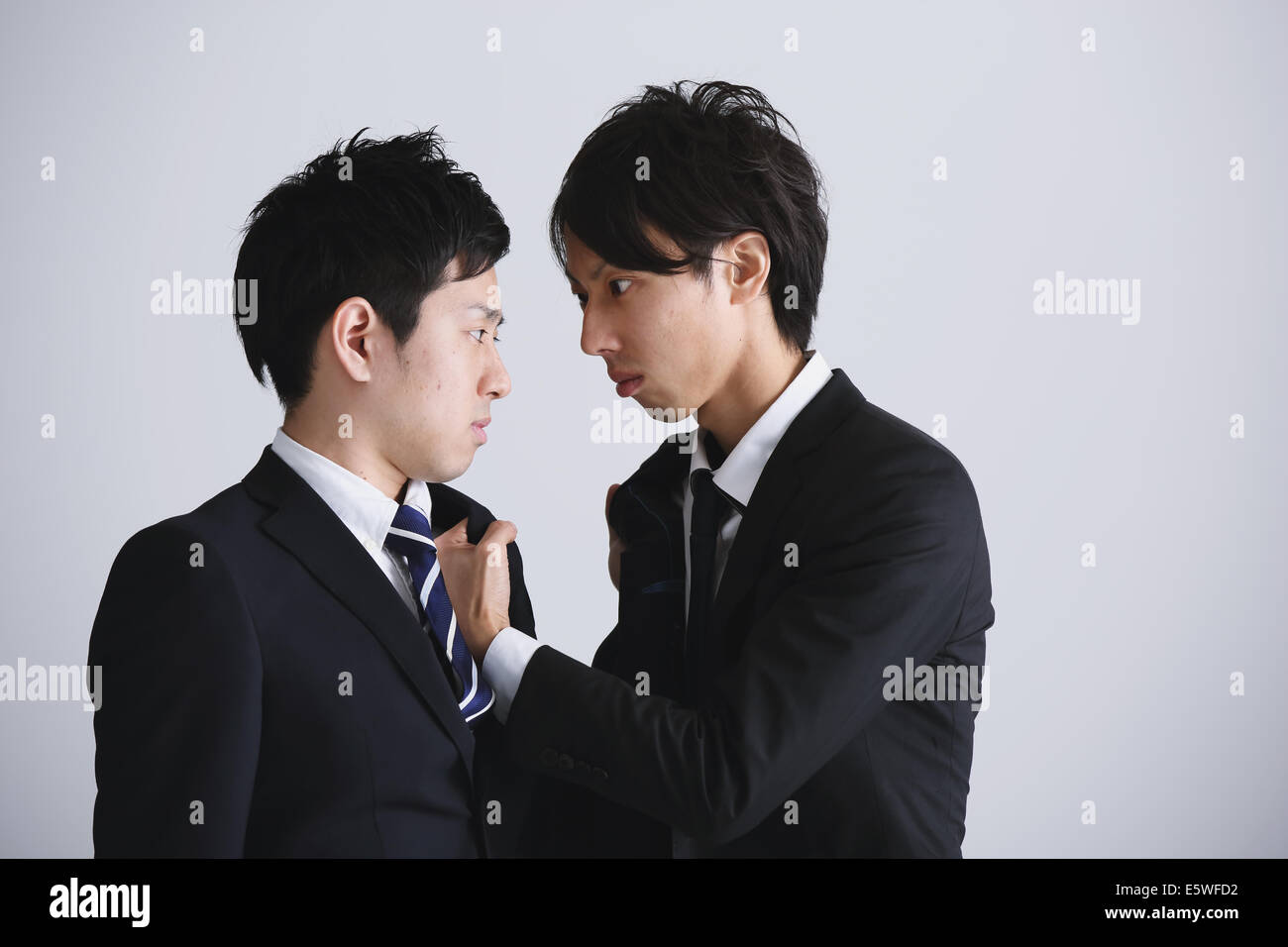 Young Japanese businessmen fighting Stock Photo - Alamy