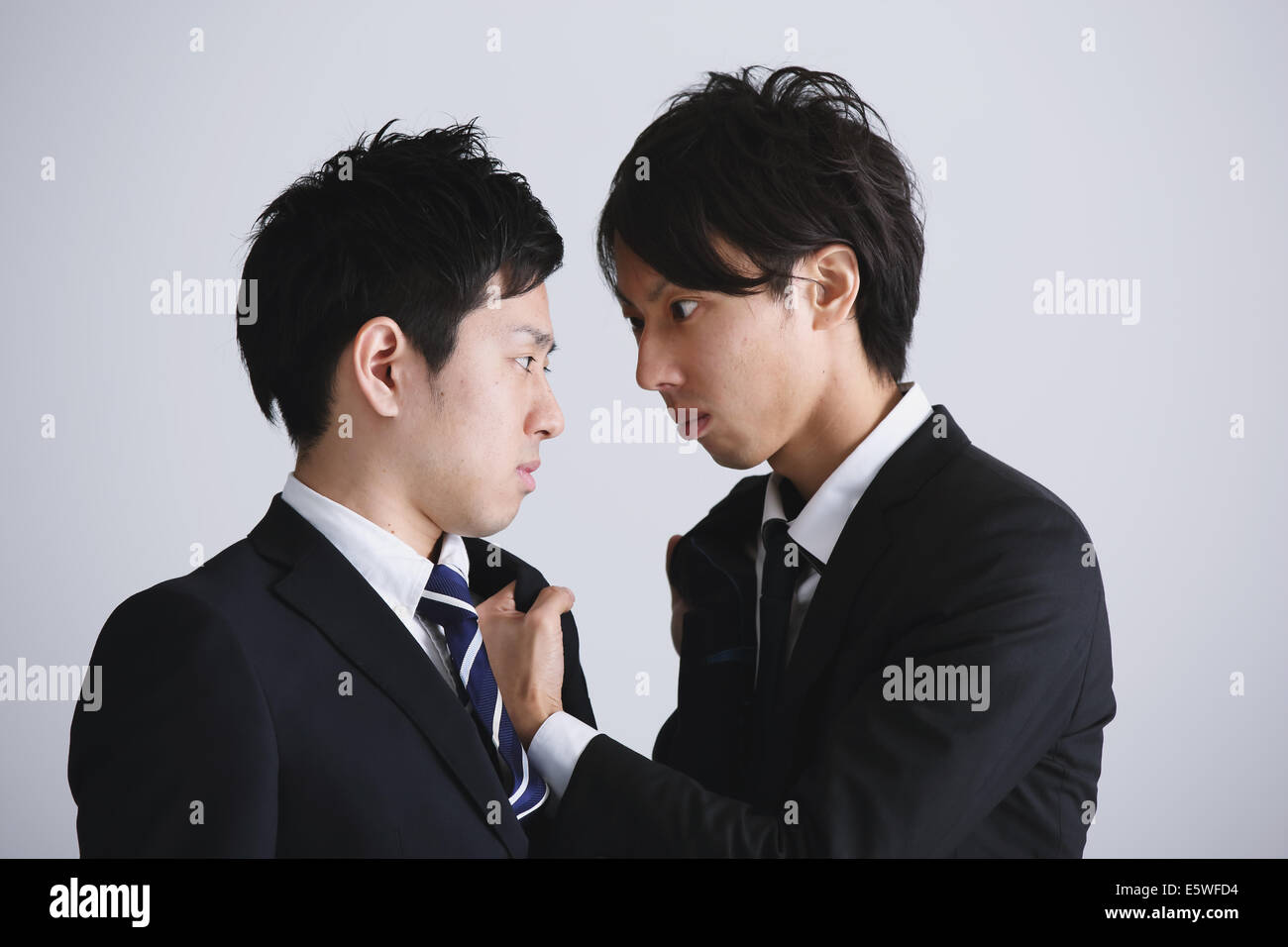 Young Japanese businessmen fighting Stock Photo - Alamy