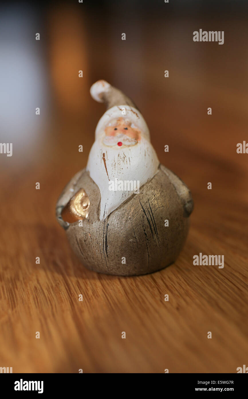 Small stylish Santa on wooden floor Stock Photo - Alamy