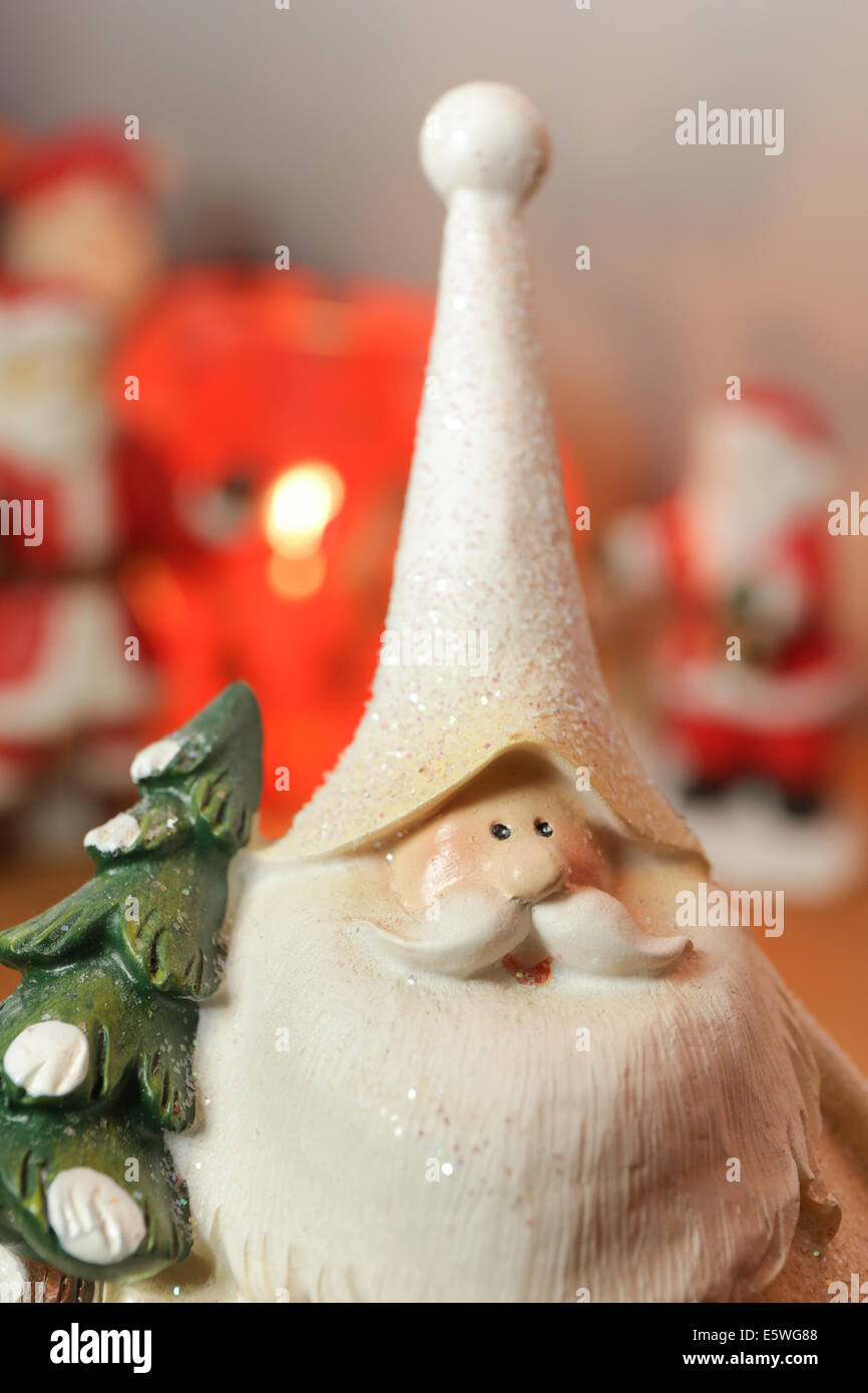 Stylish Santa carrying a Christmas tree Stock Photo - Alamy