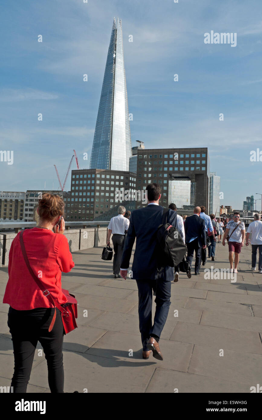 City of London office workers crossing London Bridge at rush hour after ...