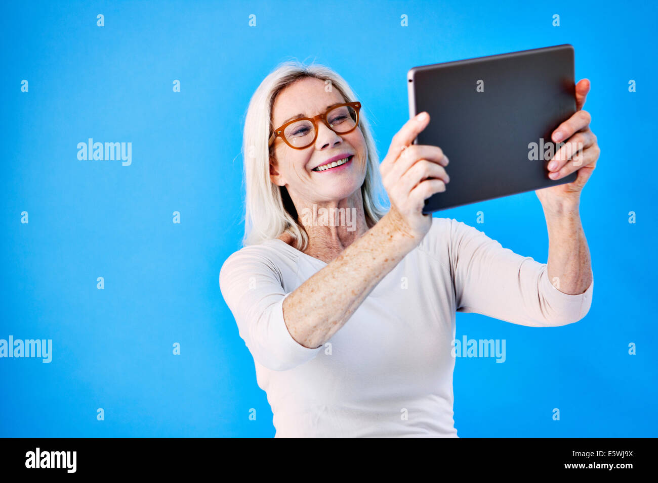 Elderly person with tablet Stock Photo - Alamy