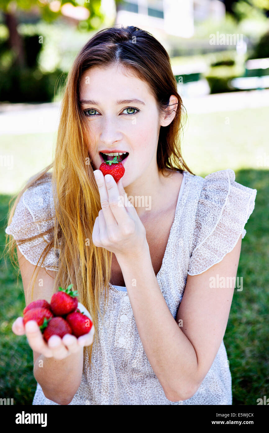 Woman eating fruit Stock Photo - Alamy