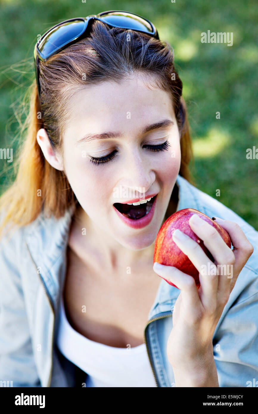 Woman eating fruit Stock Photo - Alamy