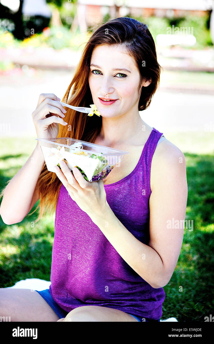 Woman eating a meal Stock Photo - Alamy