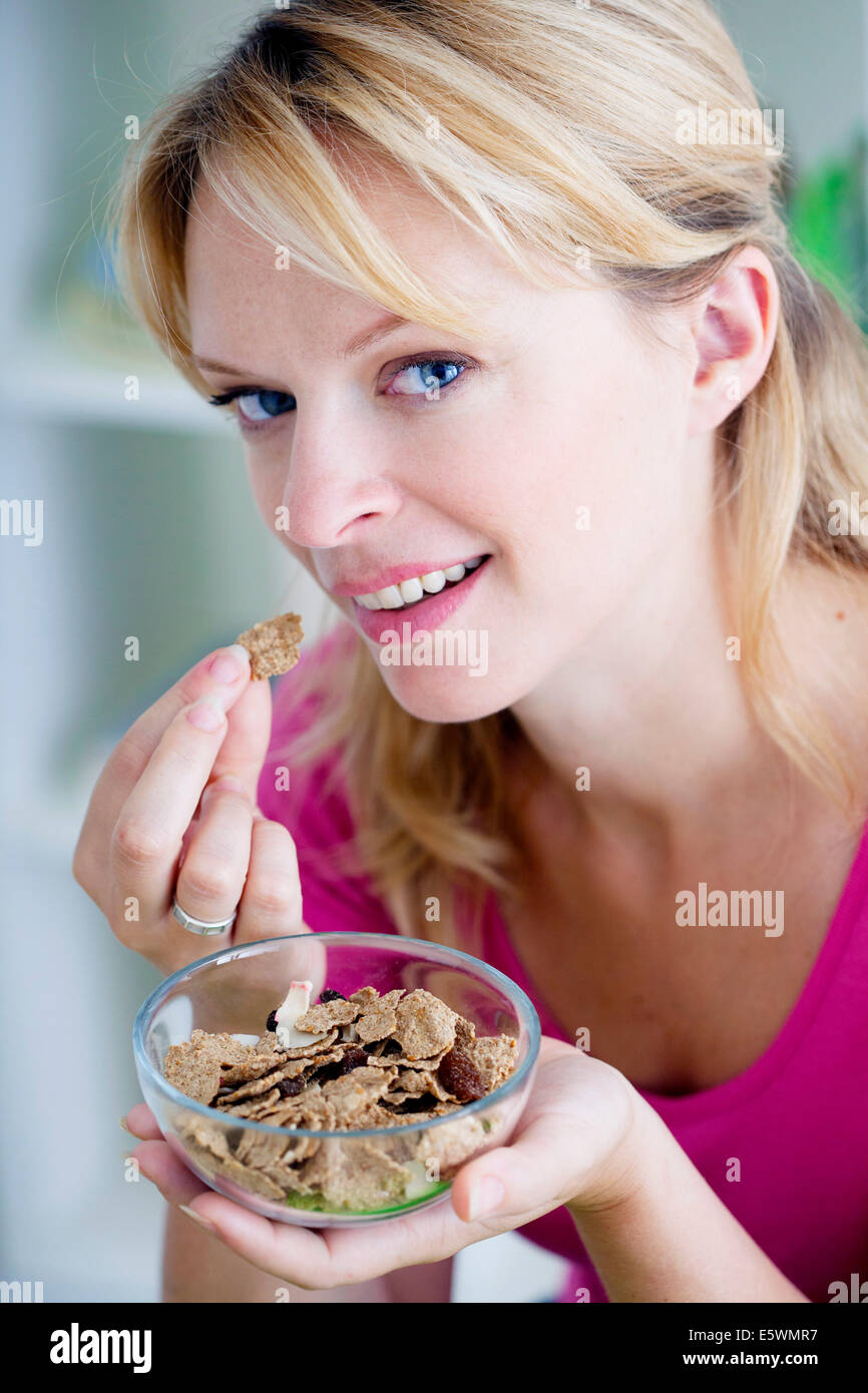 Woman eating breakfast Stock Photo - Alamy