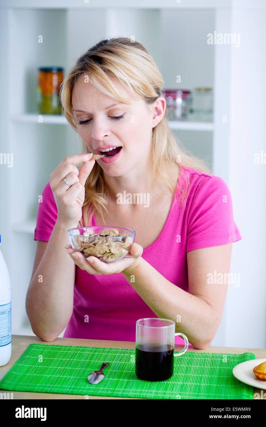 Woman eating breakfast Stock Photo - Alamy