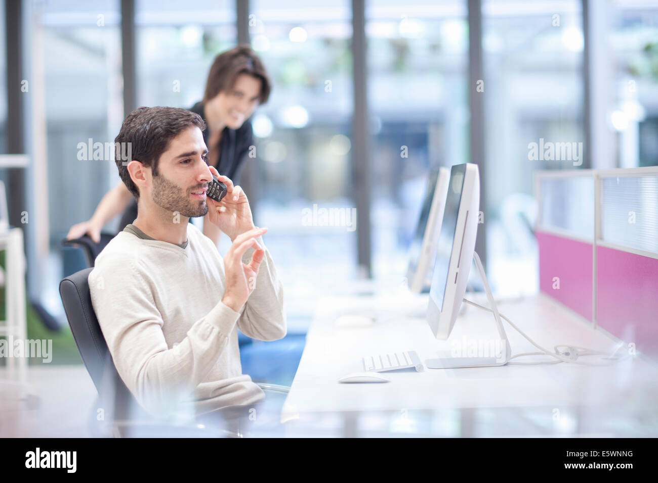 Office worker sitting on desk hi-res stock photography and images - Alamy