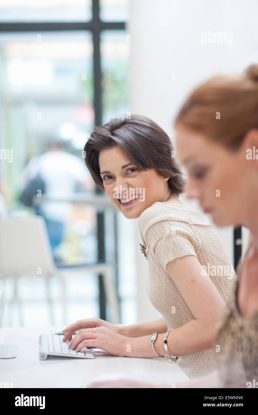 Female office worker using computer Stock Photo - Alamy