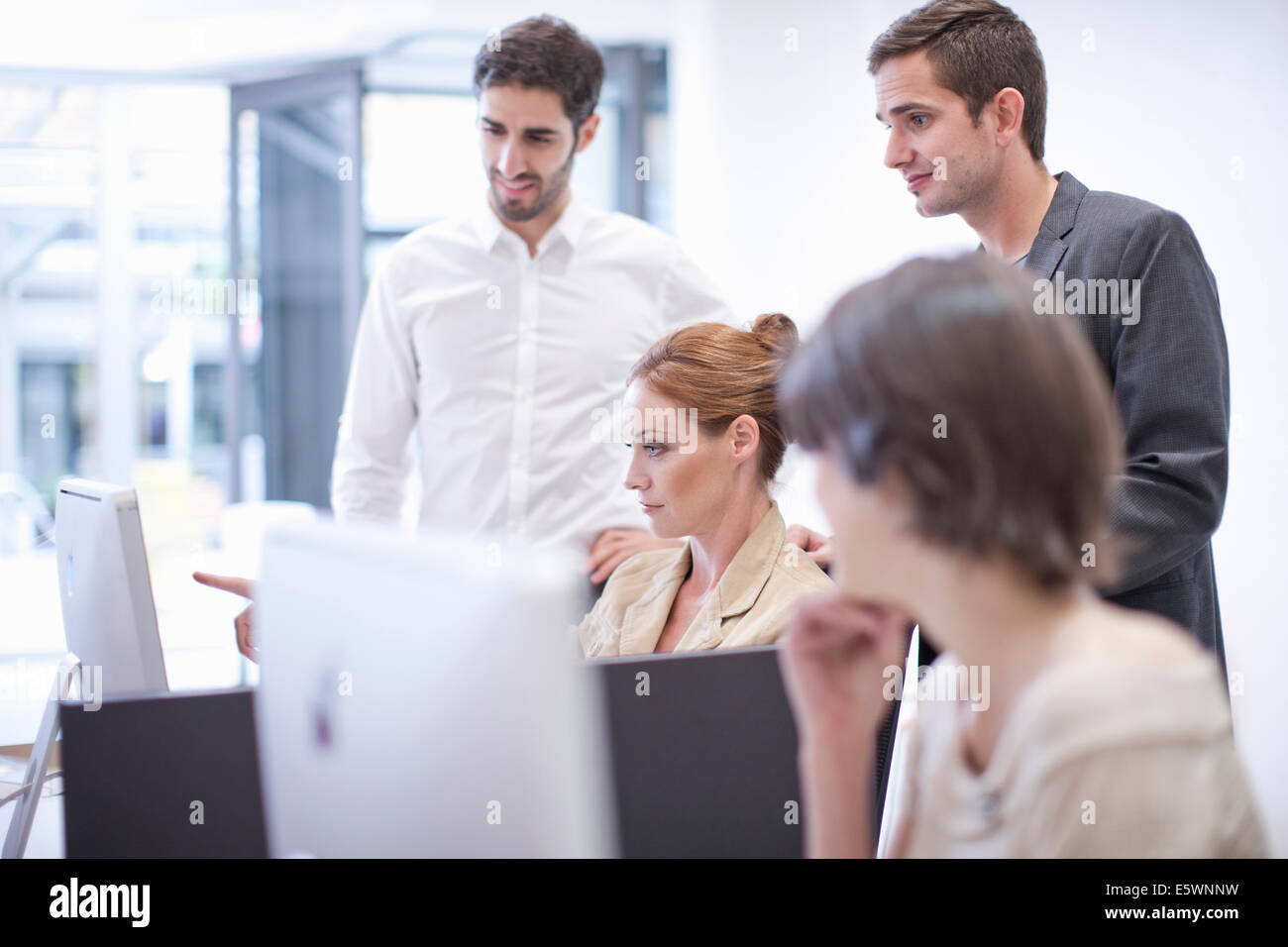 Office colleagues looking at computer Stock Photo - Alamy