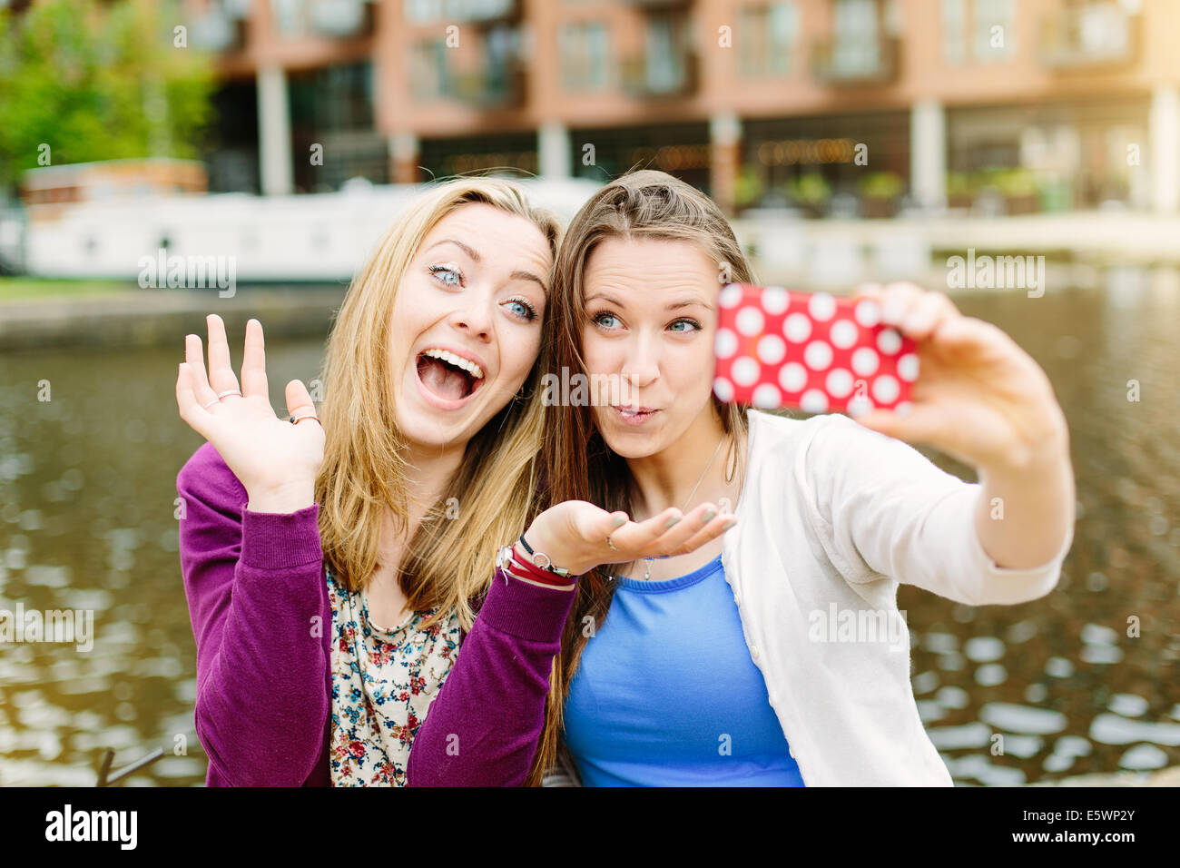 Friends taking selfie by canal Stock Photo - Alamy