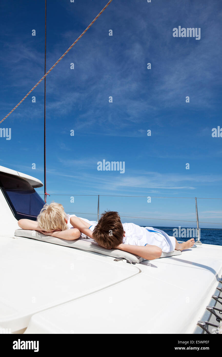 Two brothers sunbathing on catamaran near Fuerteventura, Spain Stock ...