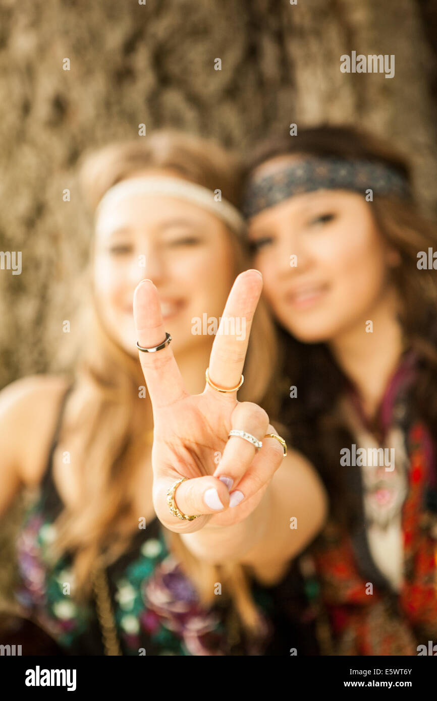 Hippy women showing peace sign Stock Photo - Alamy