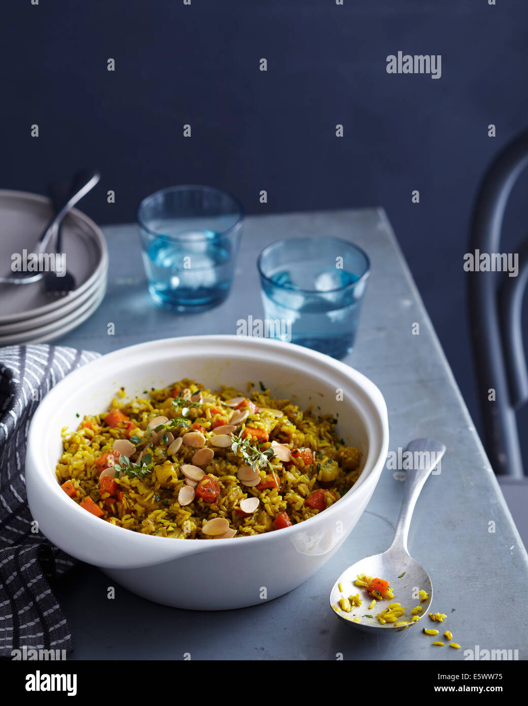 Bowl of spiced brown rice pilaf with herb garnish Stock Photo - Alamy