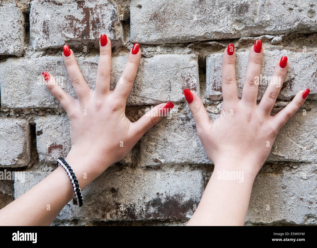 A female hands on the brick wall Stock Photo - Alamy
