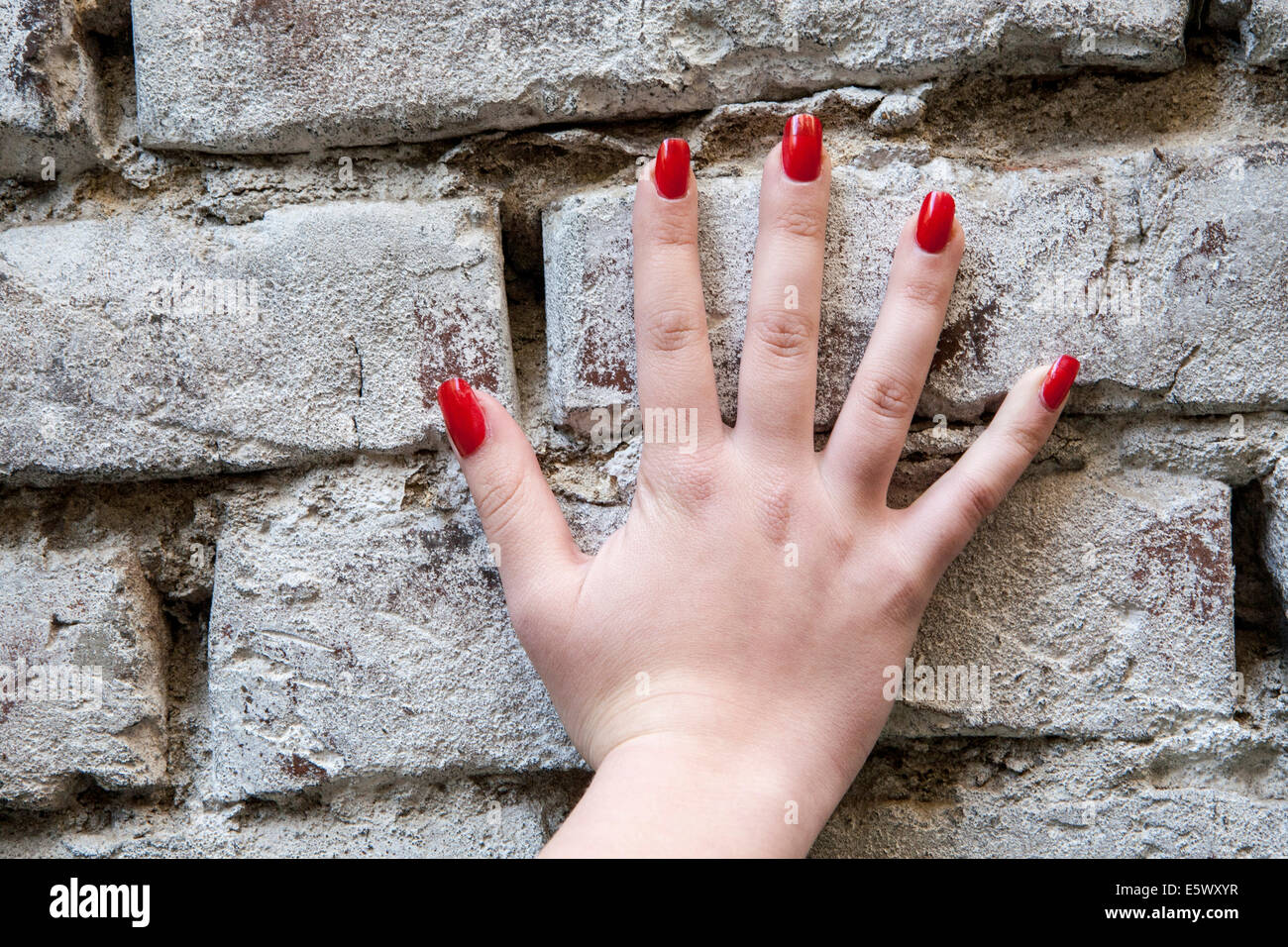 A female hand on the brick wall Stock Photo - Alamy